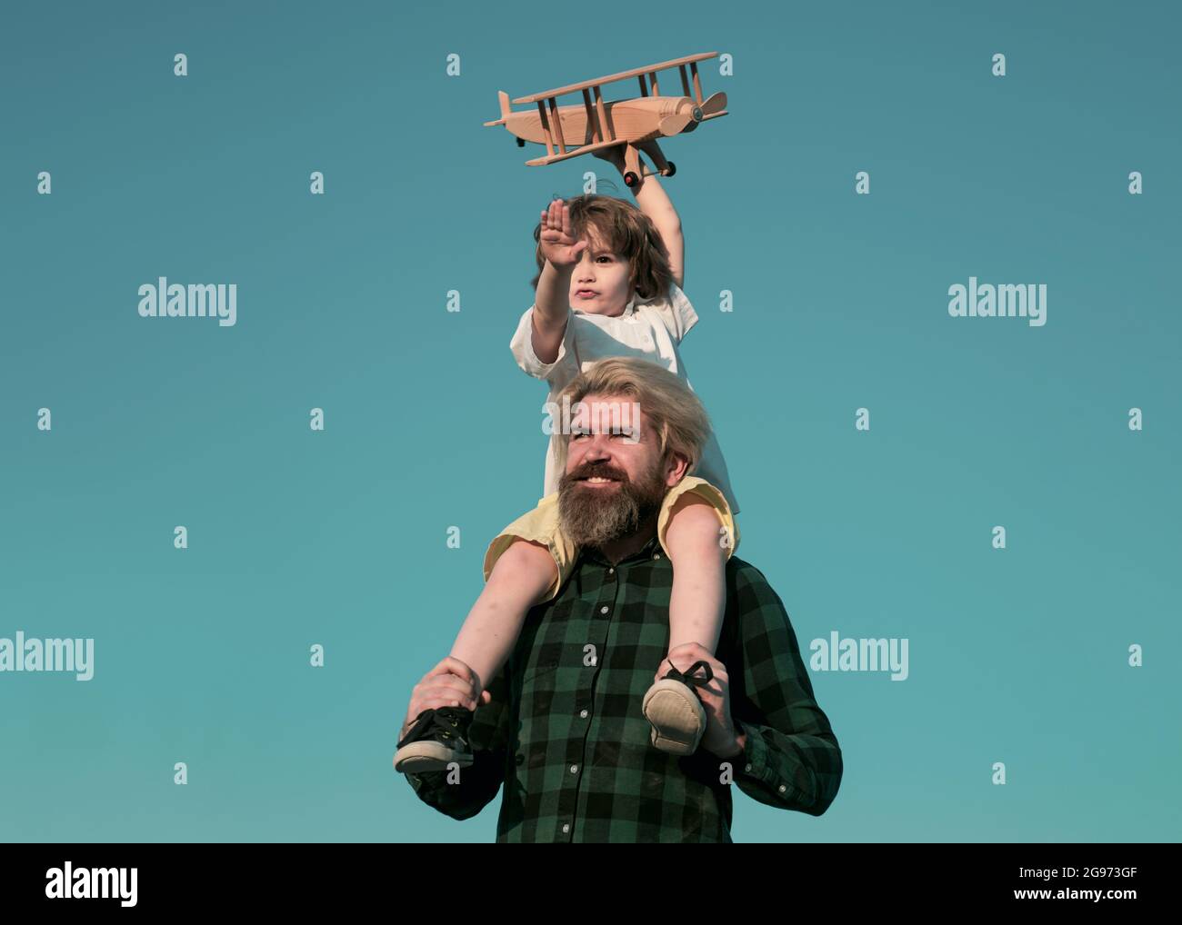 Kid boy pilot. Father and son playing with wooden airplane Stock Photo ...