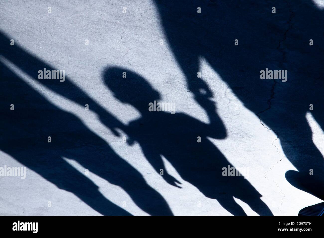 Blurry shadow silhouette of a little boy walking with parents hand in ...