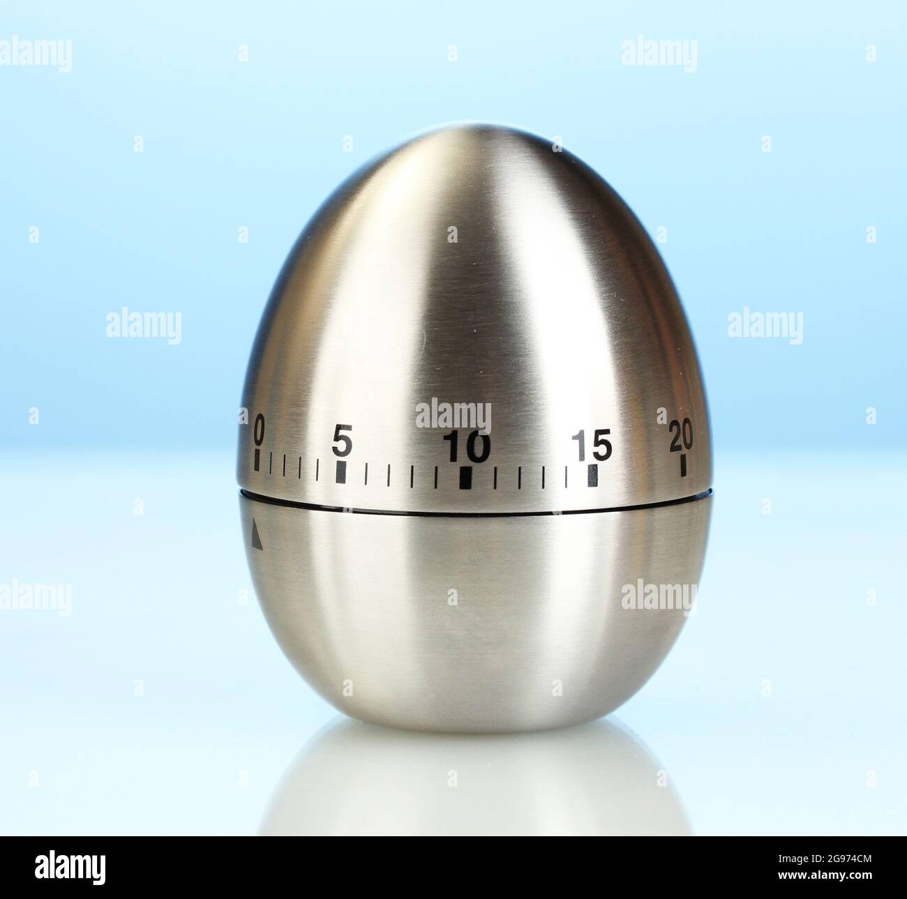 metal kitchen egg timer on a blue background Stock Photo - Alamy