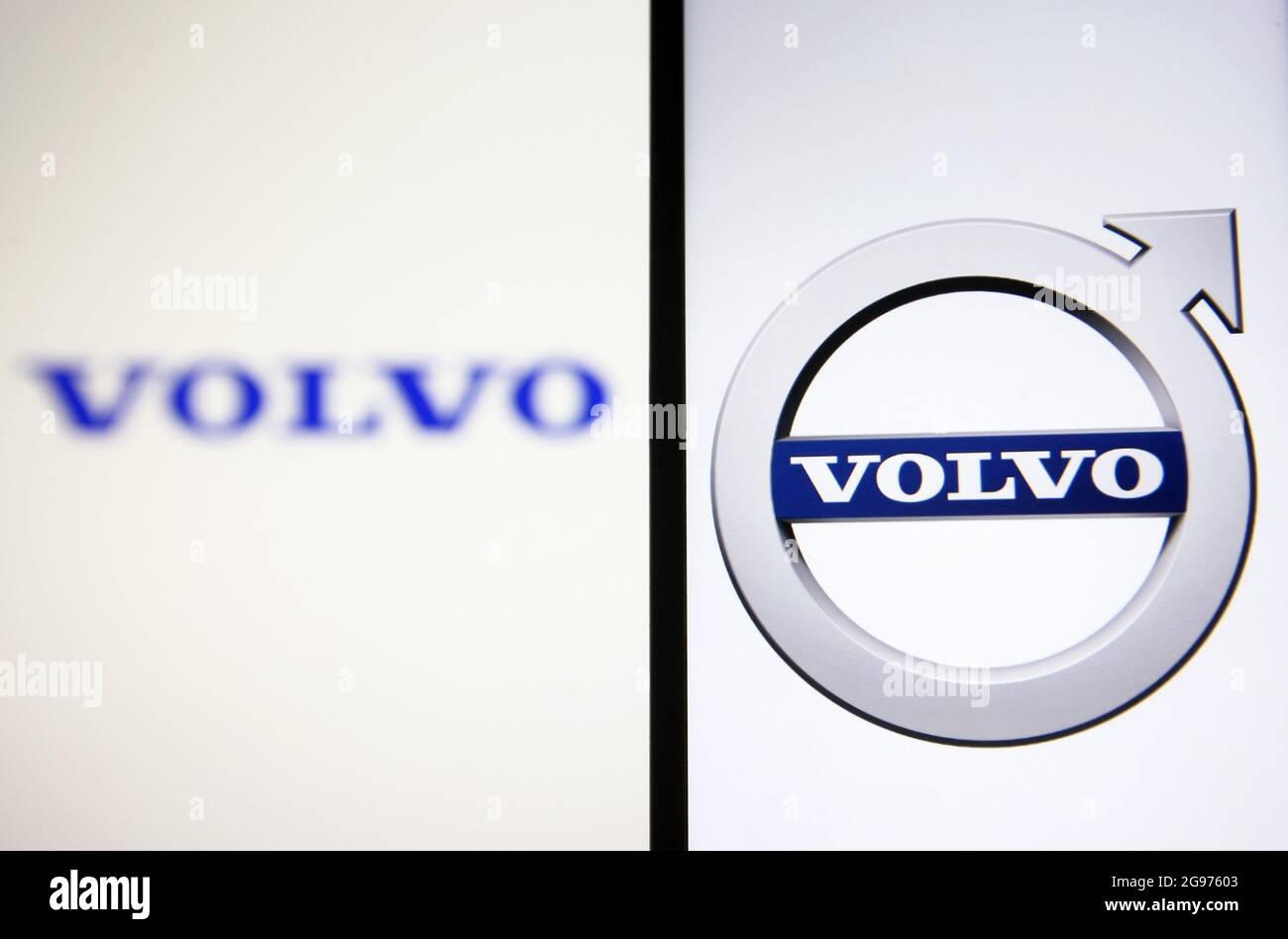 In this photo illustration a Volvo logo is seen on a smartphone and a ...