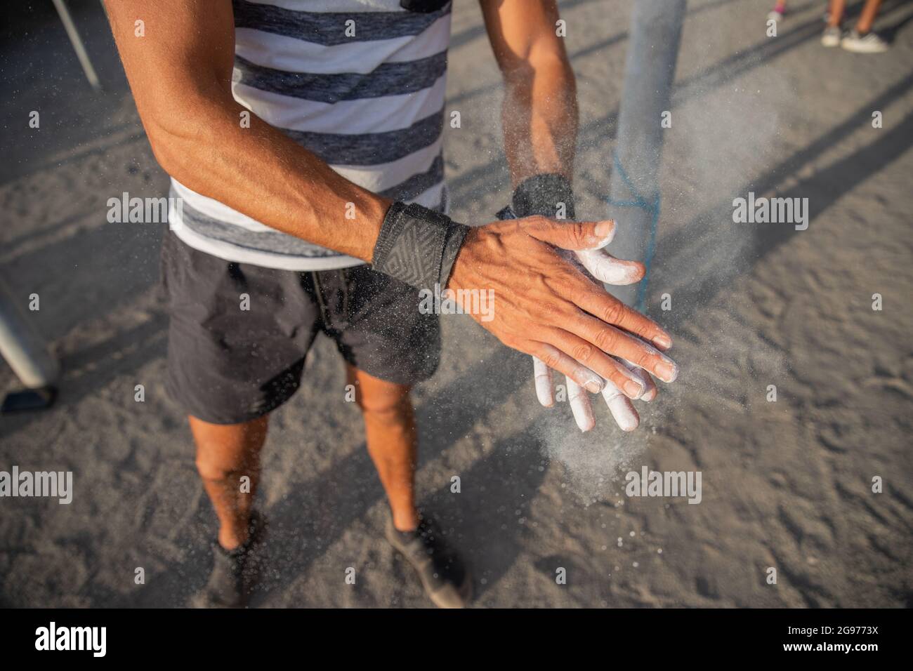 Portrait of an athlete's hands applying weightlifting Chalk Powder for ...