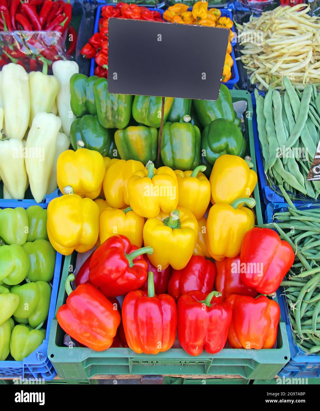 Colorful raw organic bell peppers in plastic crates sold on market ...