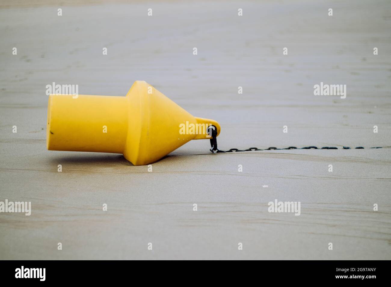 Yellow buoy on a chain on the beach hi-res stock photography and images ...