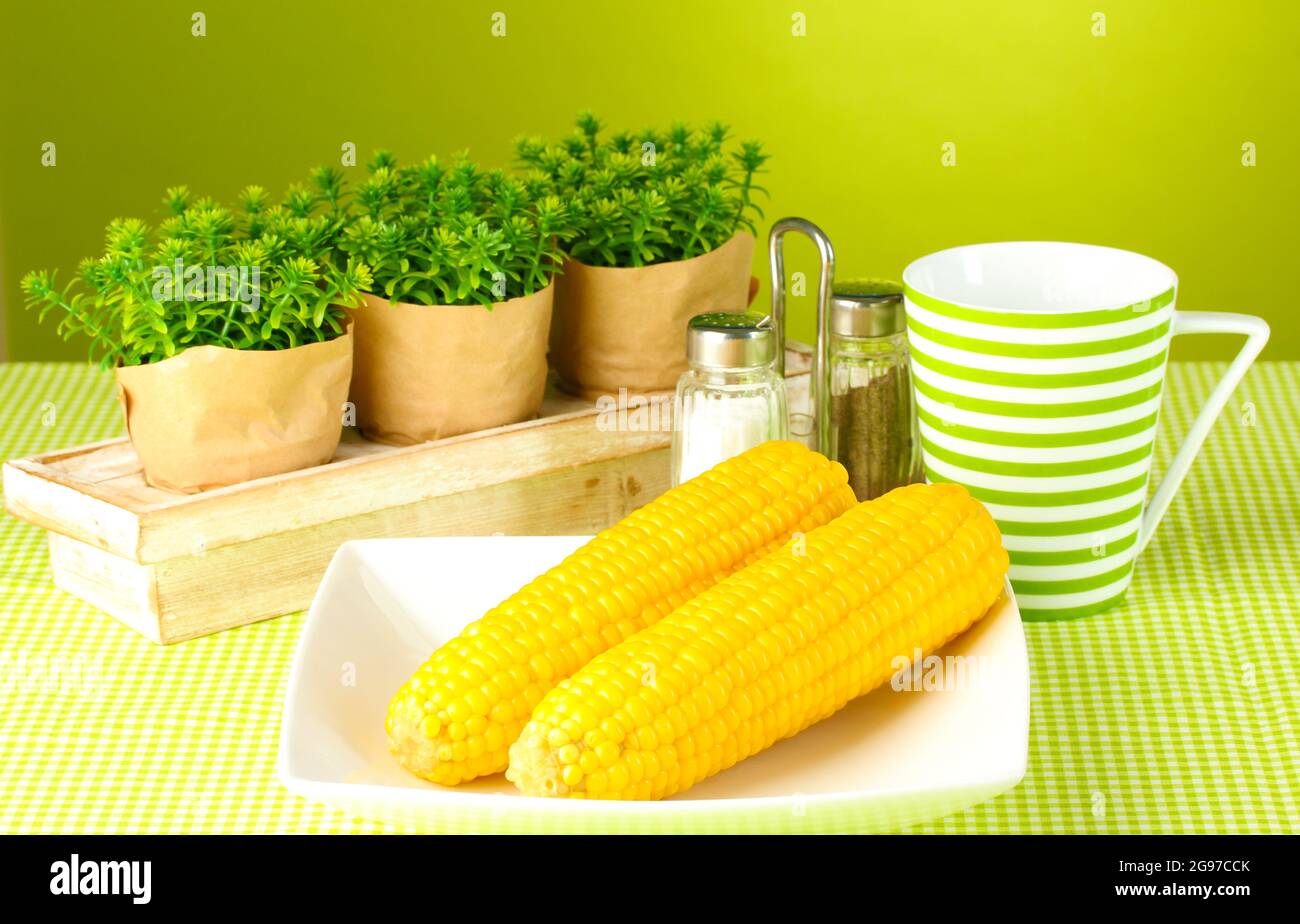 boiled corn and flowers on a green background Stock Photo - Alamy