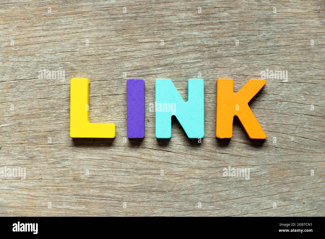 Color alphabet letter in word link on wood background Stock Photo - Alamy