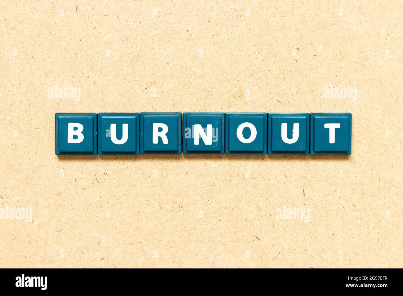 Tile alphabet letter in word bunout on wood background Stock Photo - Alamy