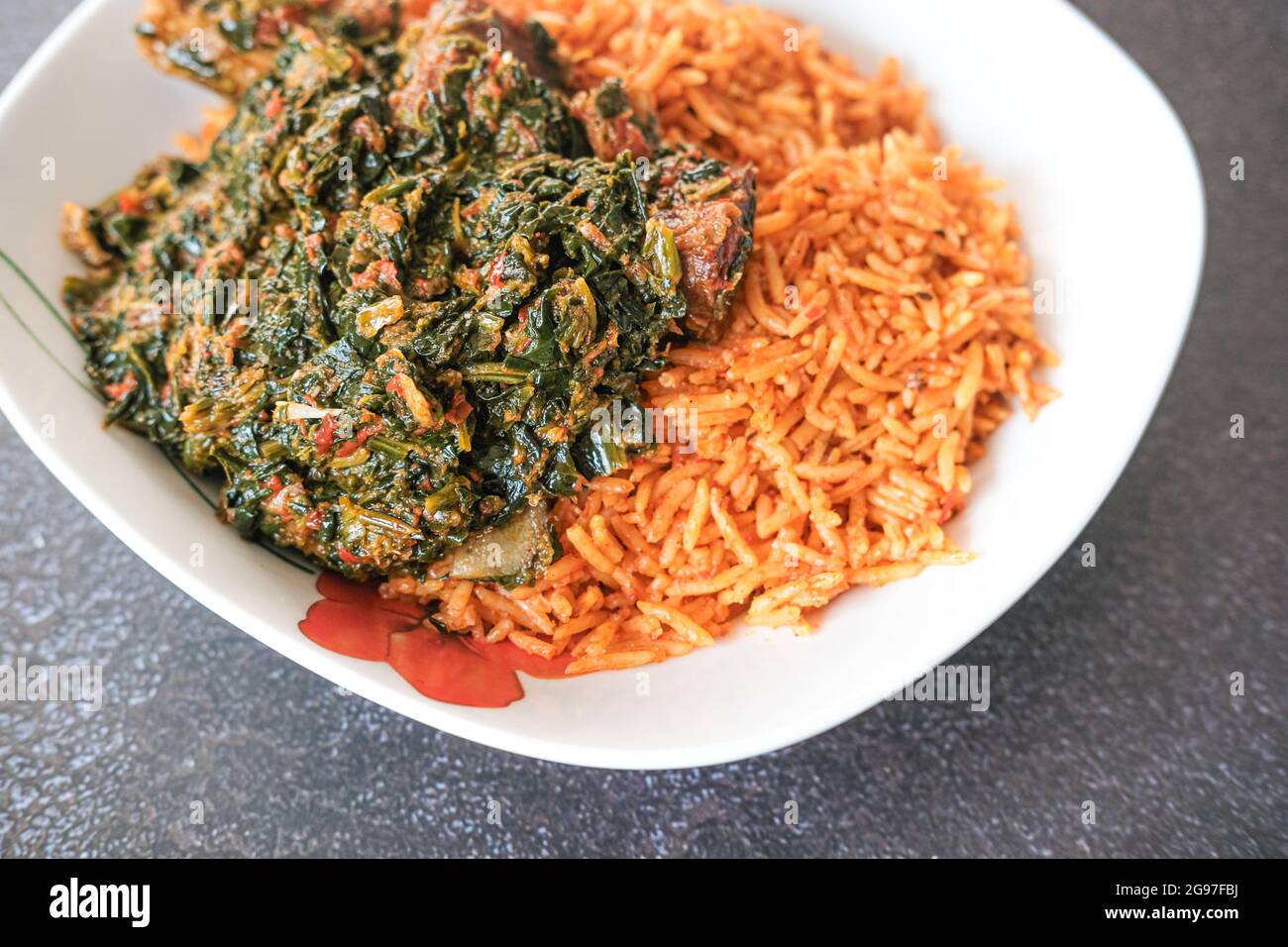 Spicy Tasty Nigerian Jollof with Vegetable Soup Stock Photo - Alamy