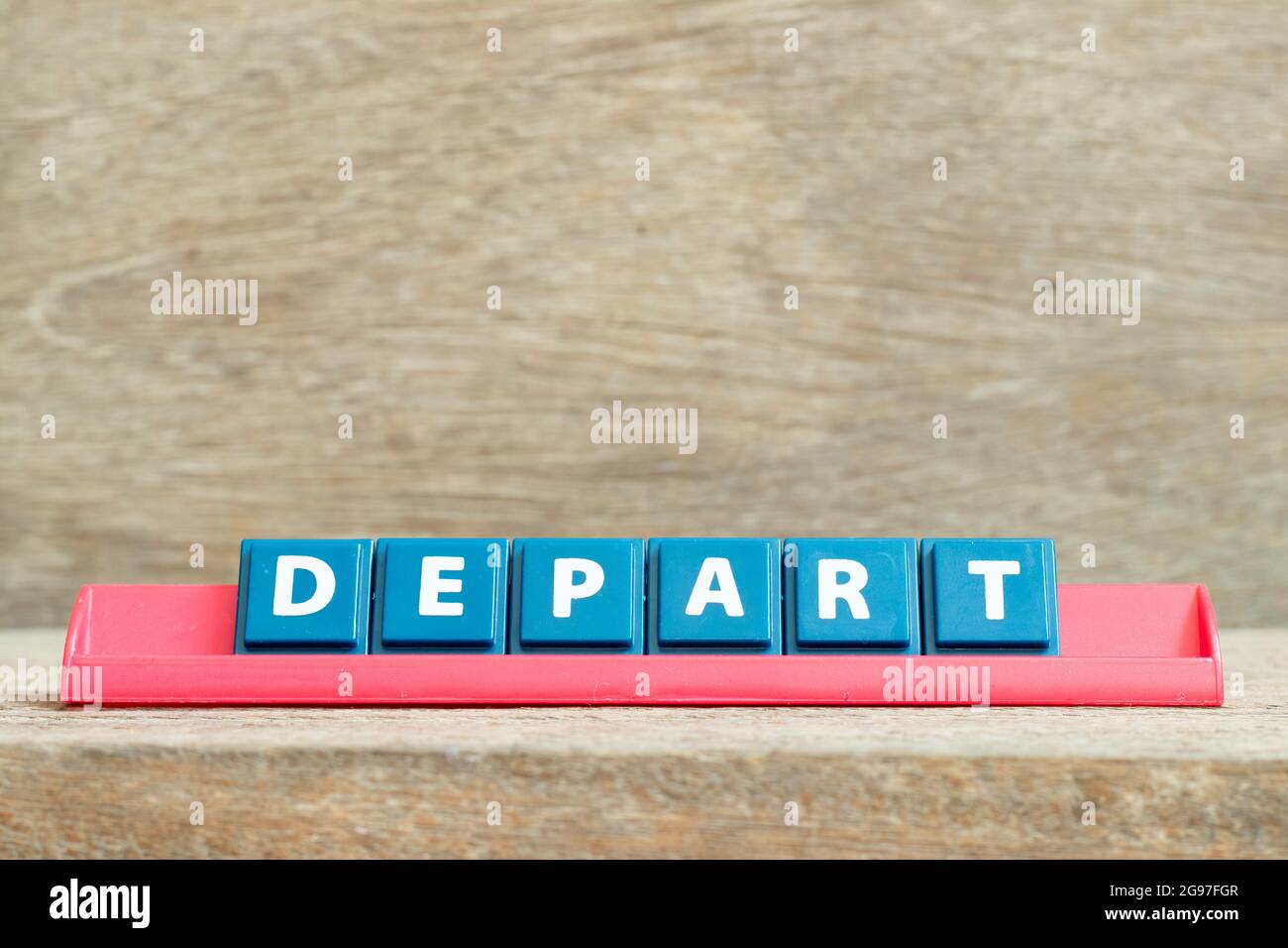 Tile alphabet letter with word depart in red color rack on wood ...