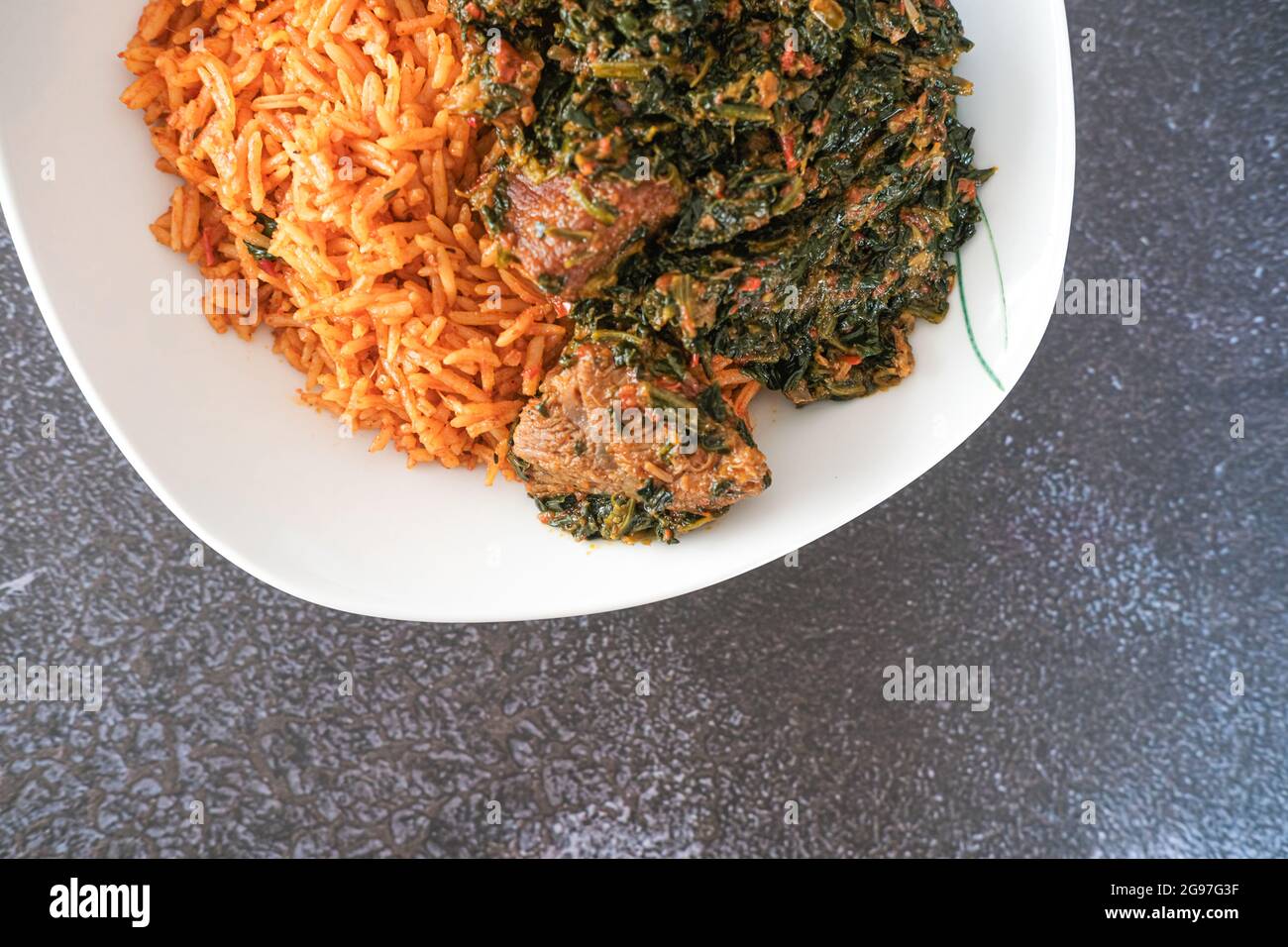 Spicy Tasty Nigerian Jollof with Vegetable Soup Stock Photo - Alamy
