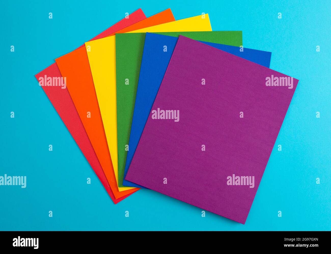 Rainbow Folders of School or Office Supplies on a Blue Background Stock ...