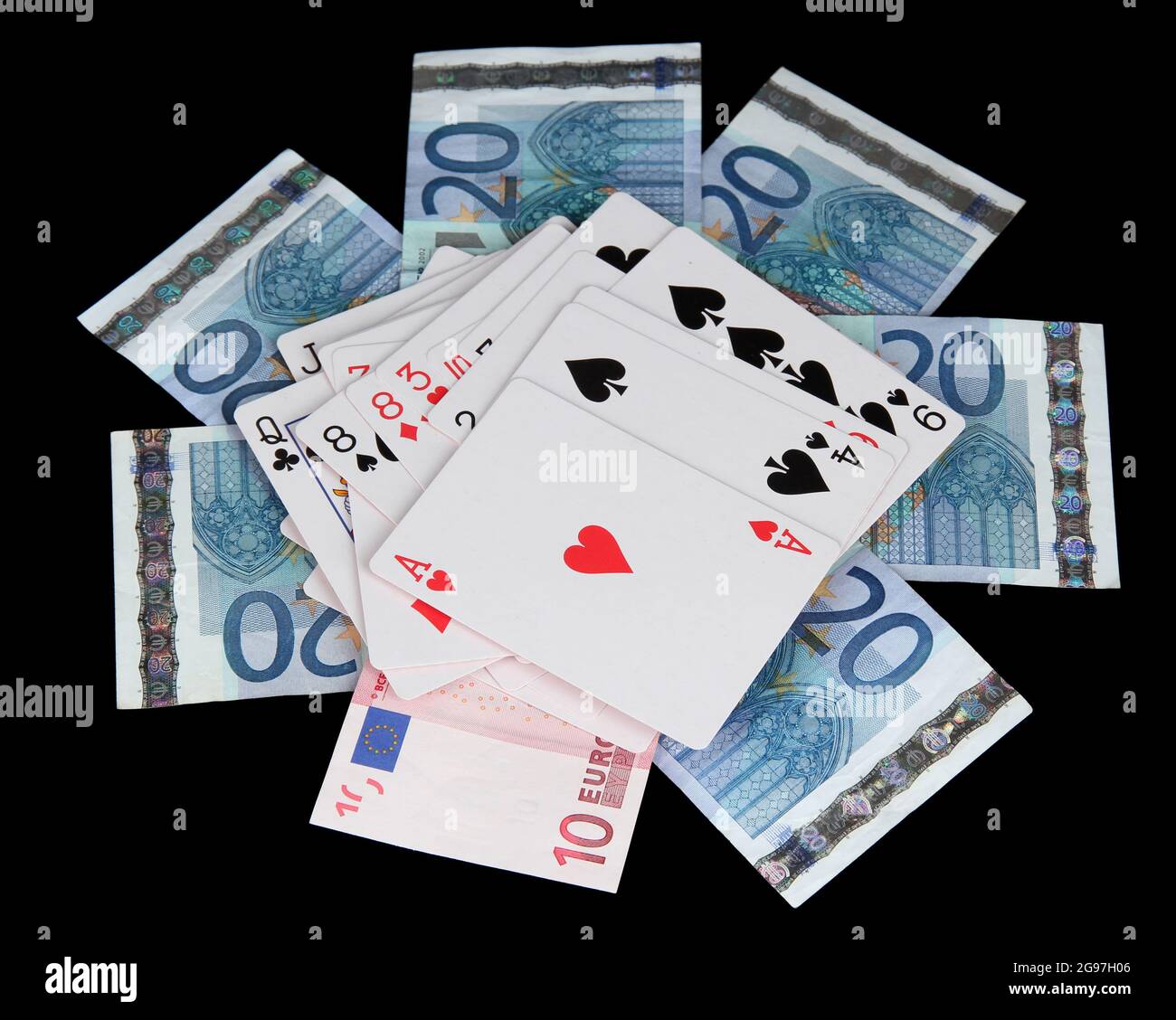 Euro and a deck of playing cards isolated on black Stock Photo - Alamy