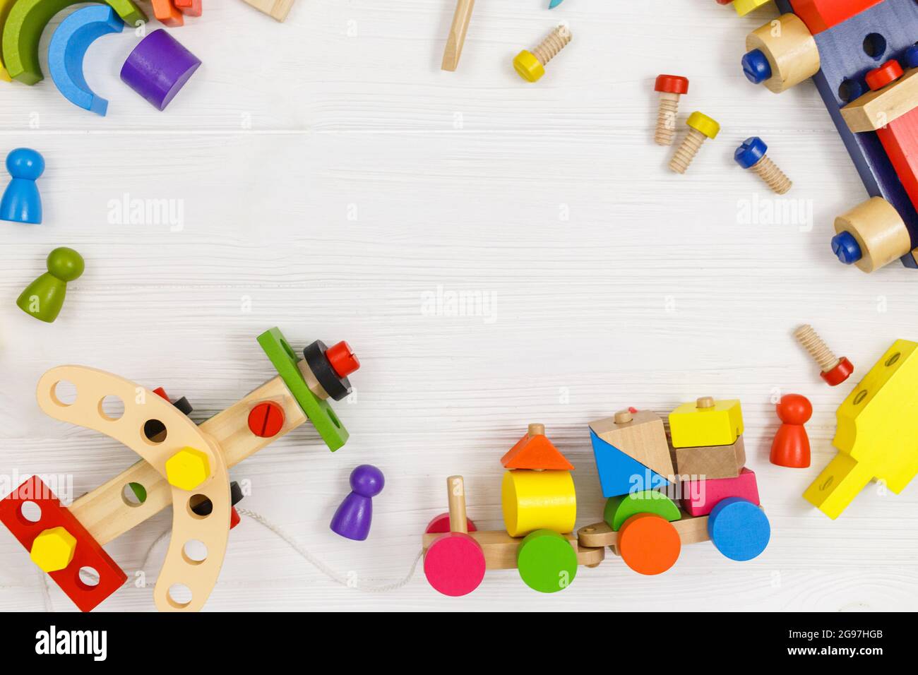 A colorful wooden building kit for children on wood. Set of tools on ...