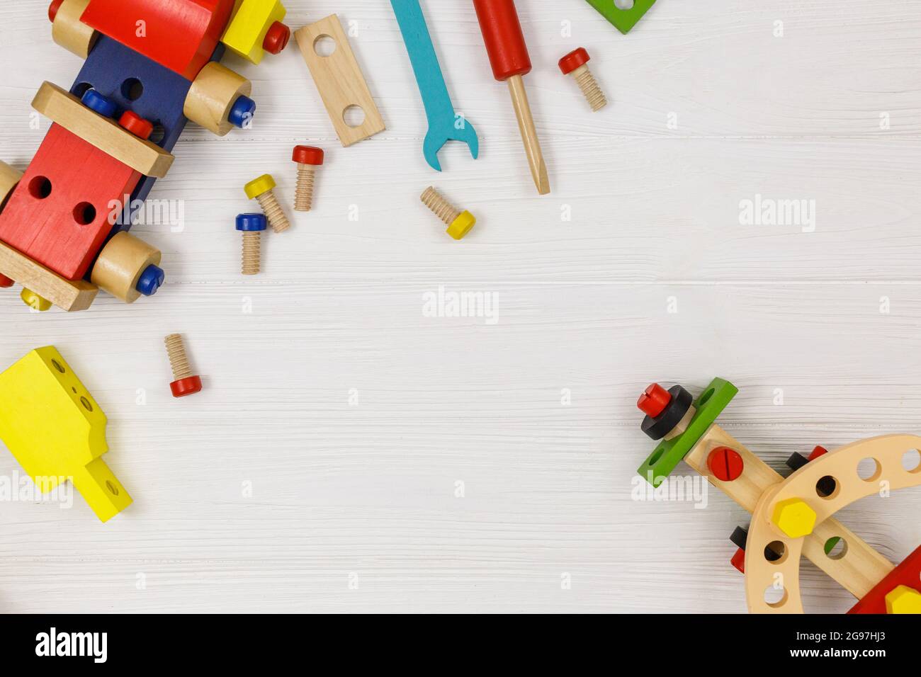 A colorful wooden building kit for children on wood. Set of tools on ...