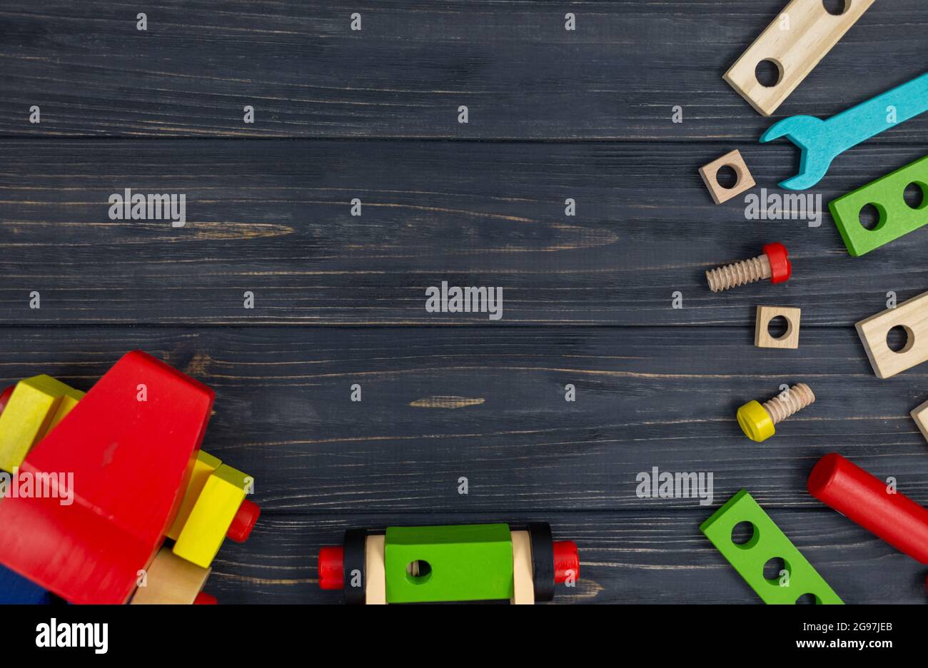 A colorful wooden building kit for children on wood. Set of tools on ...