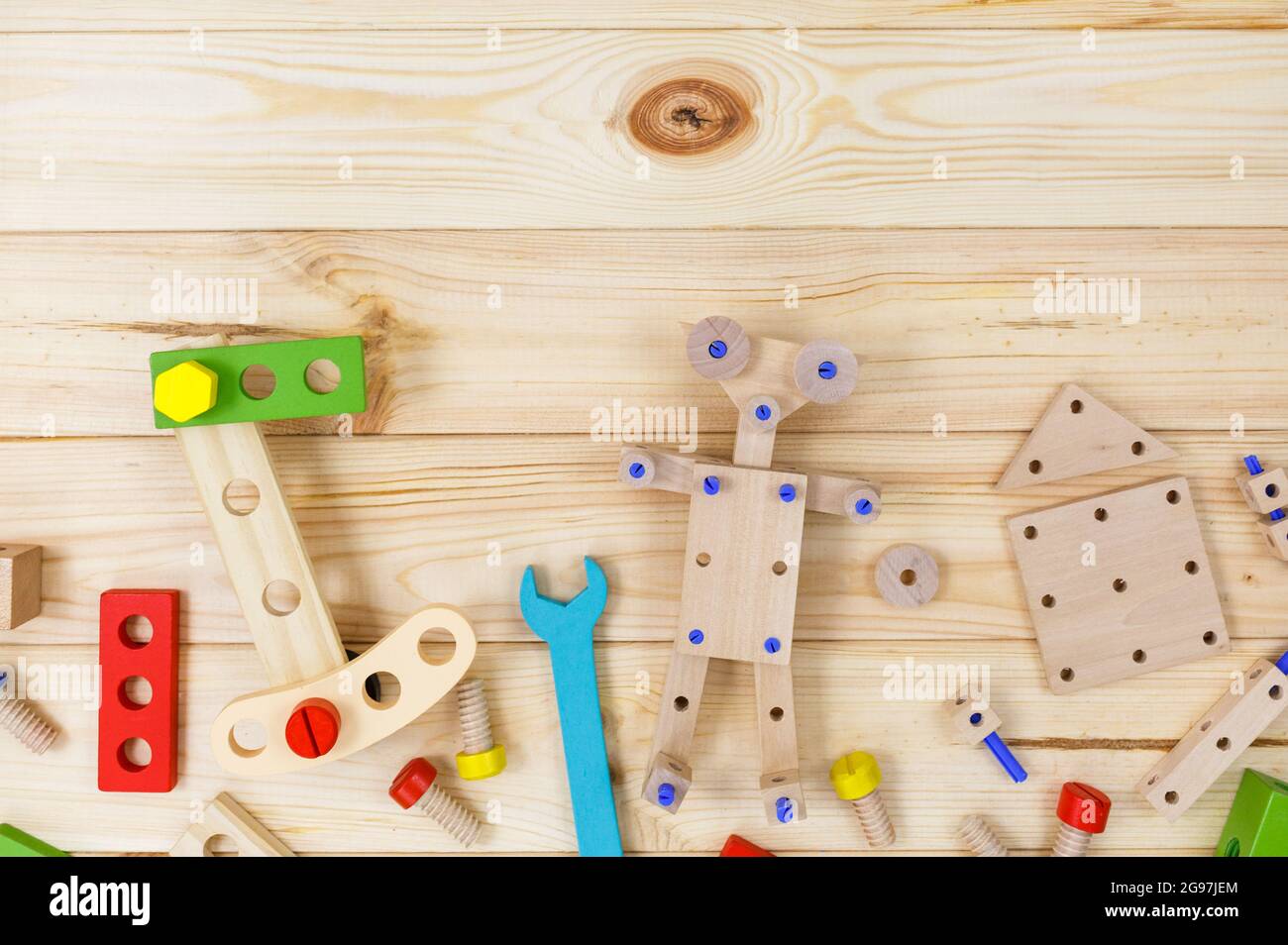A colorful wooden building kit for children on wood. Set of tools on ...