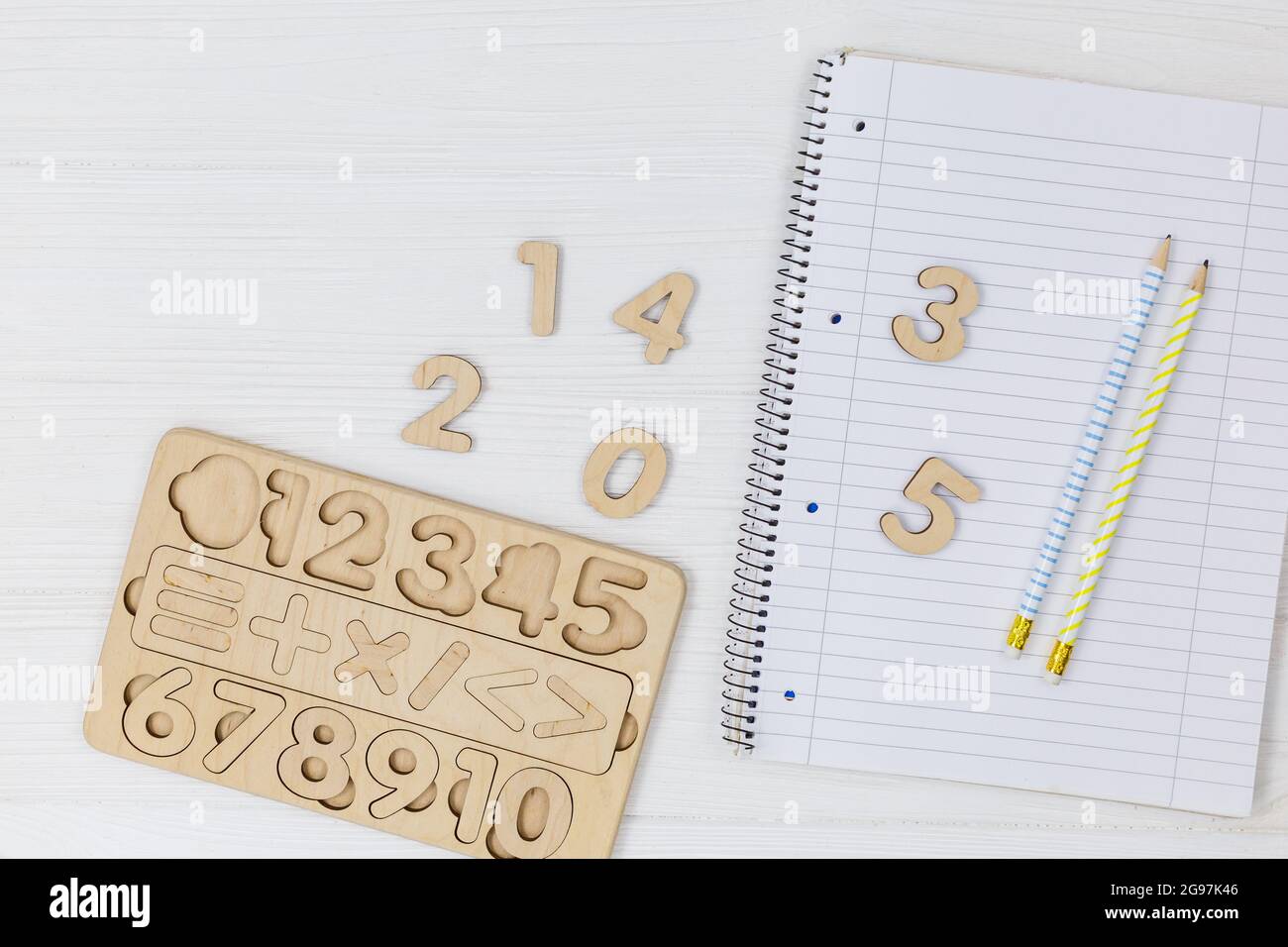 Wooden blocks with ABC letters, open notepad, numbers on wooden table ...