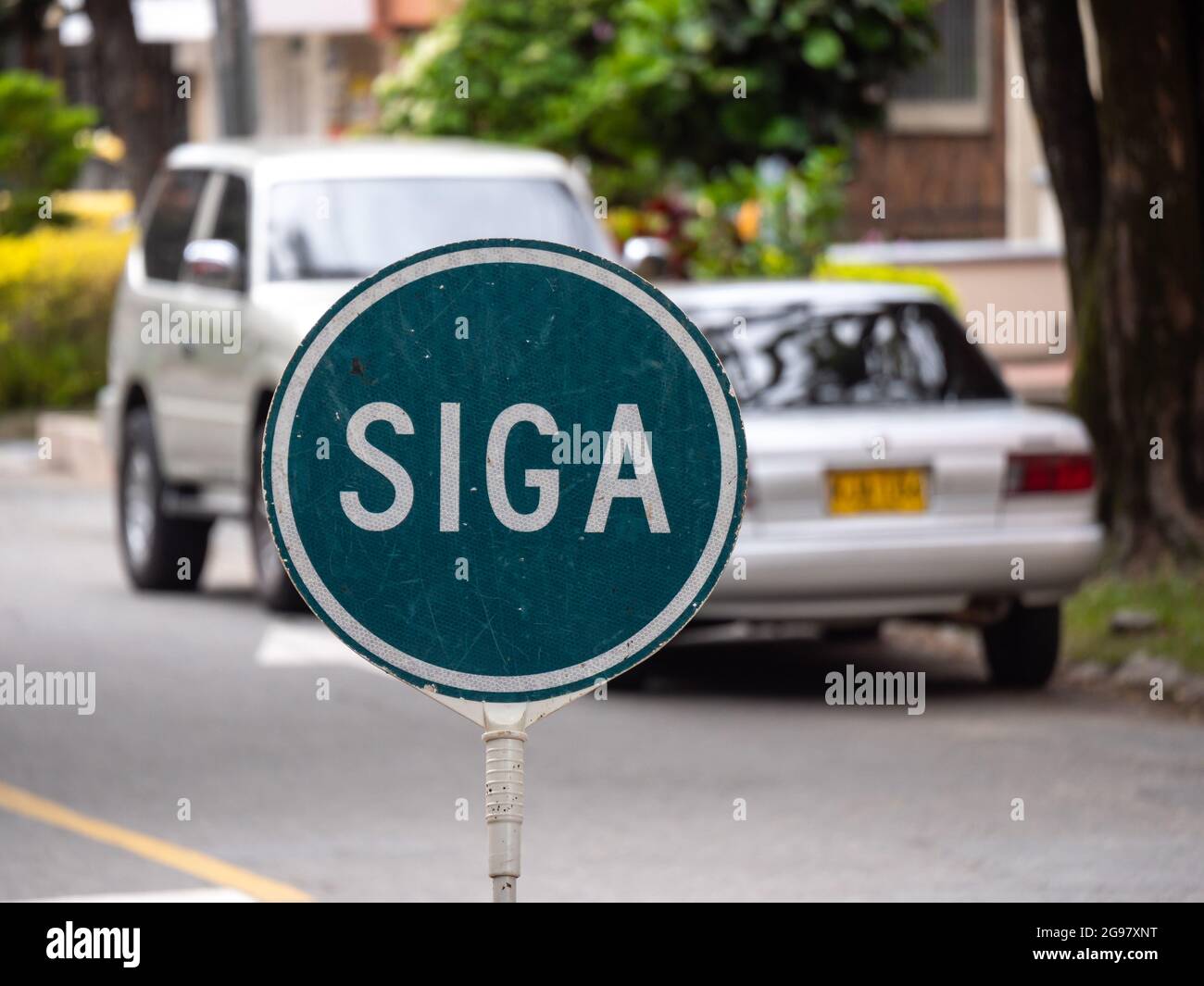 Round Blue Road Sign in the Street That Reads: "Siga (Continue Stock ...