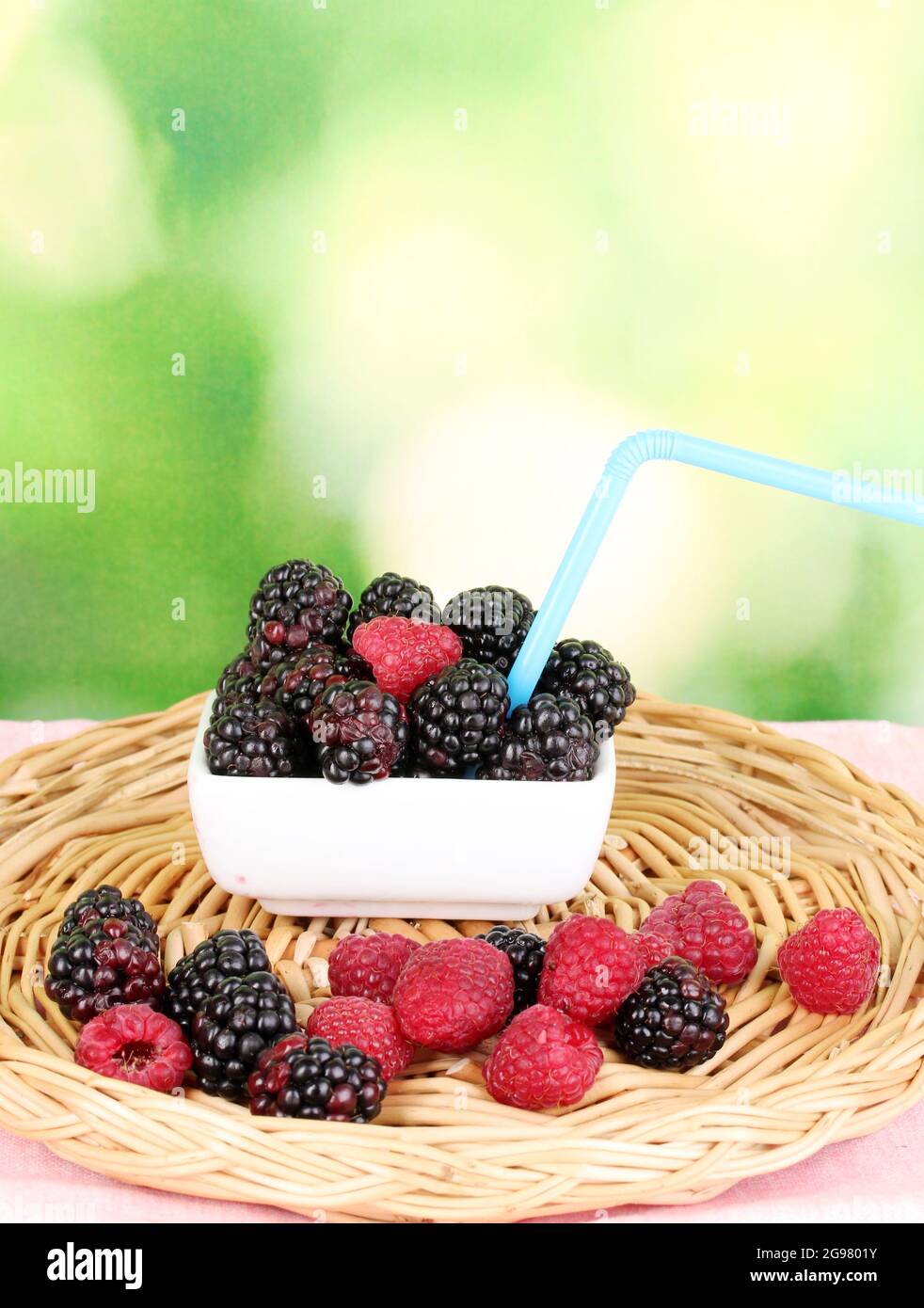 Ripe raspberries and brambles on nature background Stock Photo - Alamy