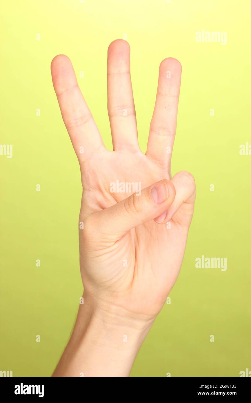 Hand making sign on green background Stock Photo - Alamy
