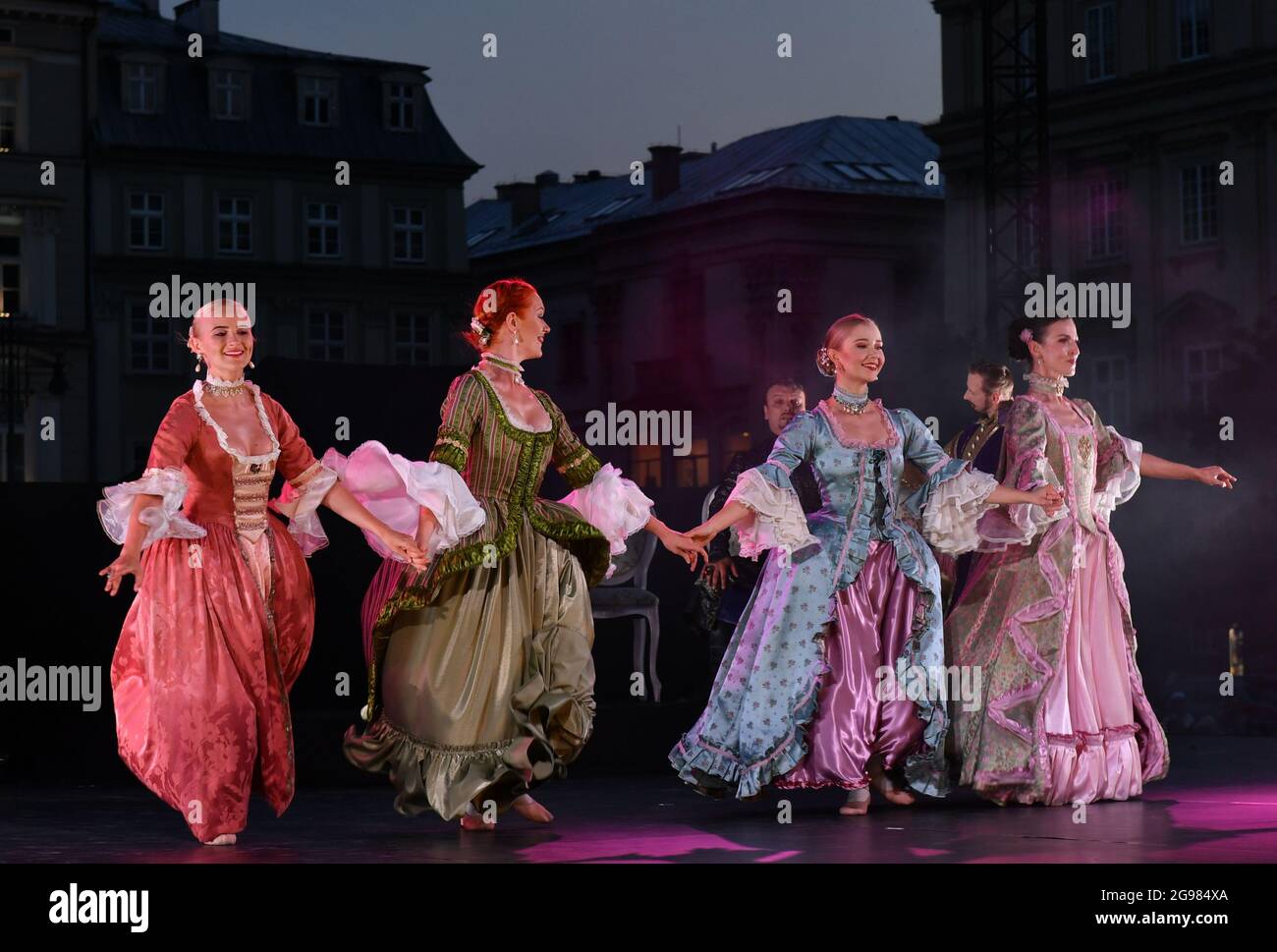 Artists in costumes performing on stage during a show of court dances ...