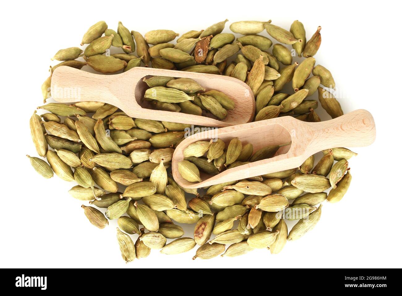 green cardamom in wooden spoons isolated on white close-up Stock Photo ...