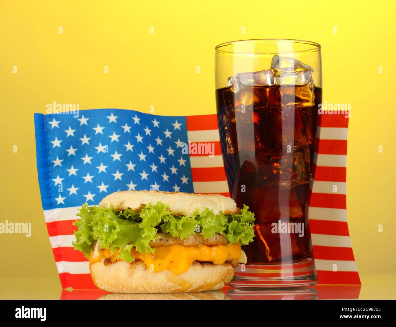 tasty sandwich and cola with american flag, on yellow background Stock ...