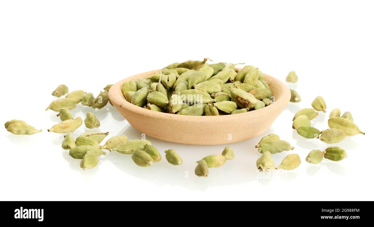 Green cardamon in ceramical bowl isolated on white Stock Photo - Alamy