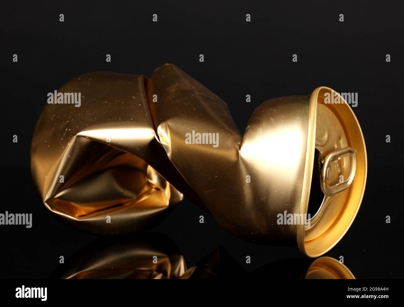 crumpled empty can isolated on black Stock Photo - Alamy