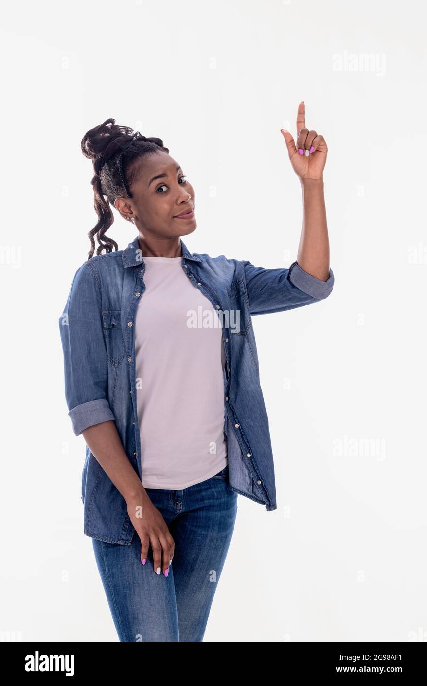 Confident African American woman pointing up and looking at camera ...