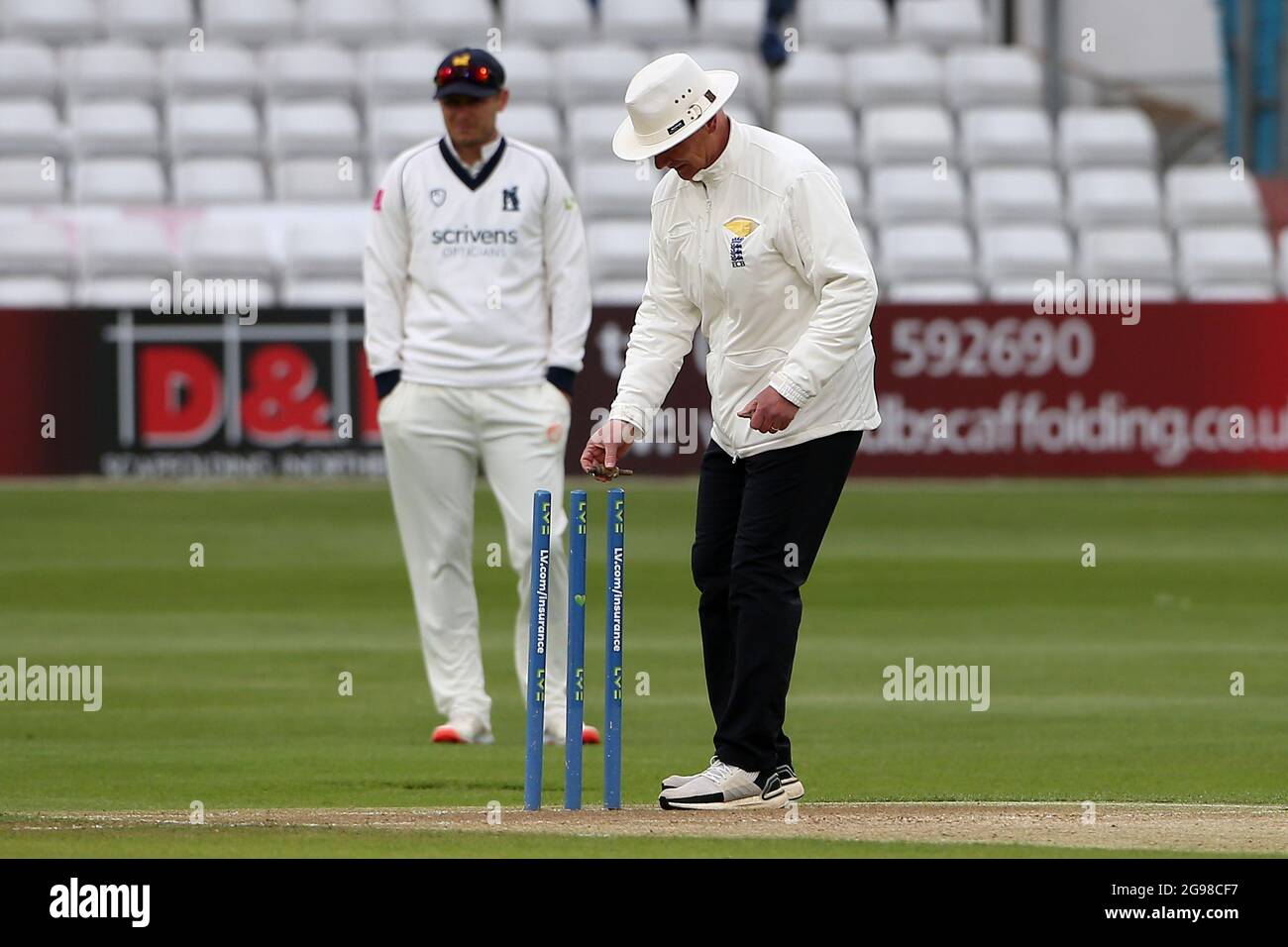 Umpire Ben Debenham replace the normal bails with heavy ones to stop ...