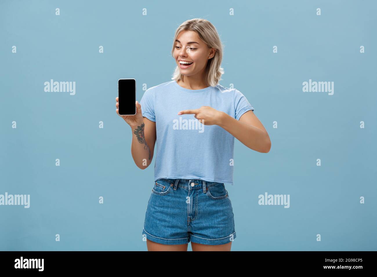 Portrait of delighted good-looking european female with blond haircut ...