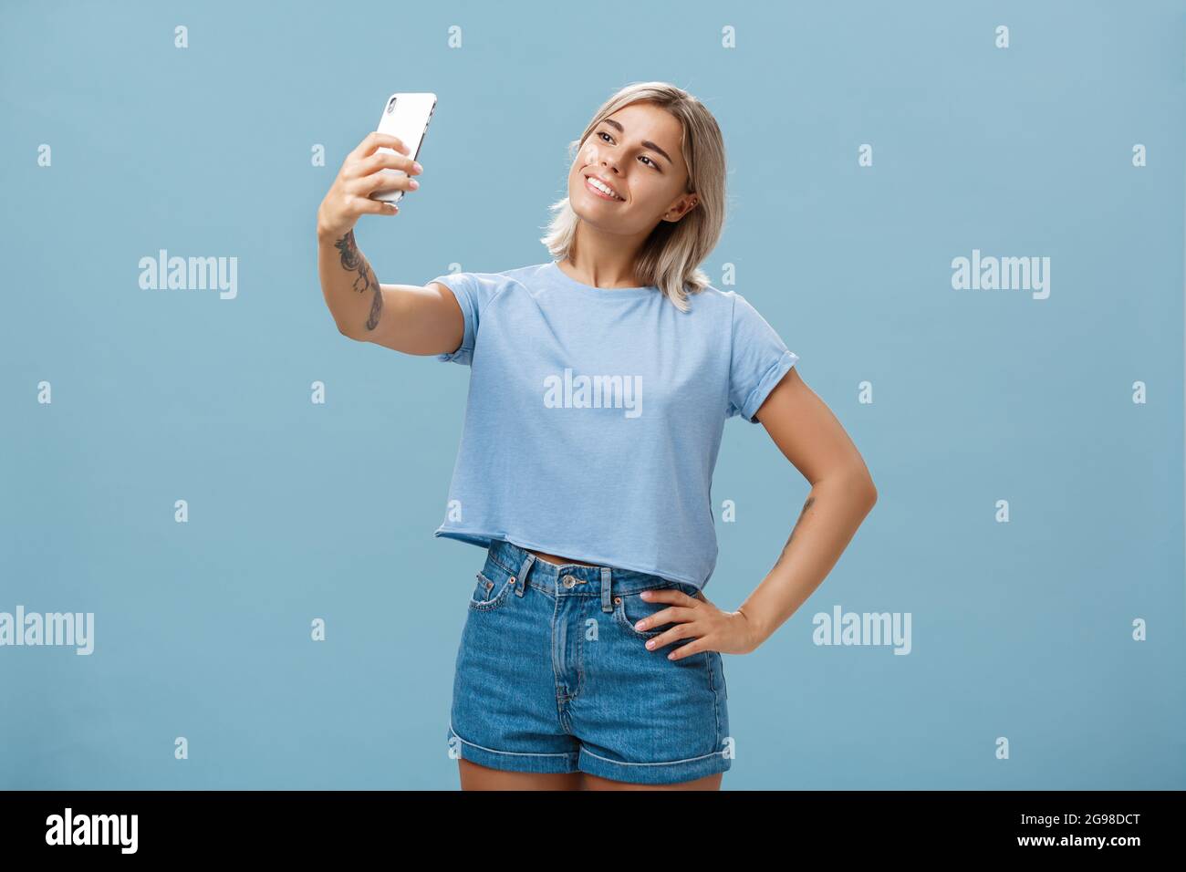 Stylish cute female gym manager taking selfie with new smartphone ...