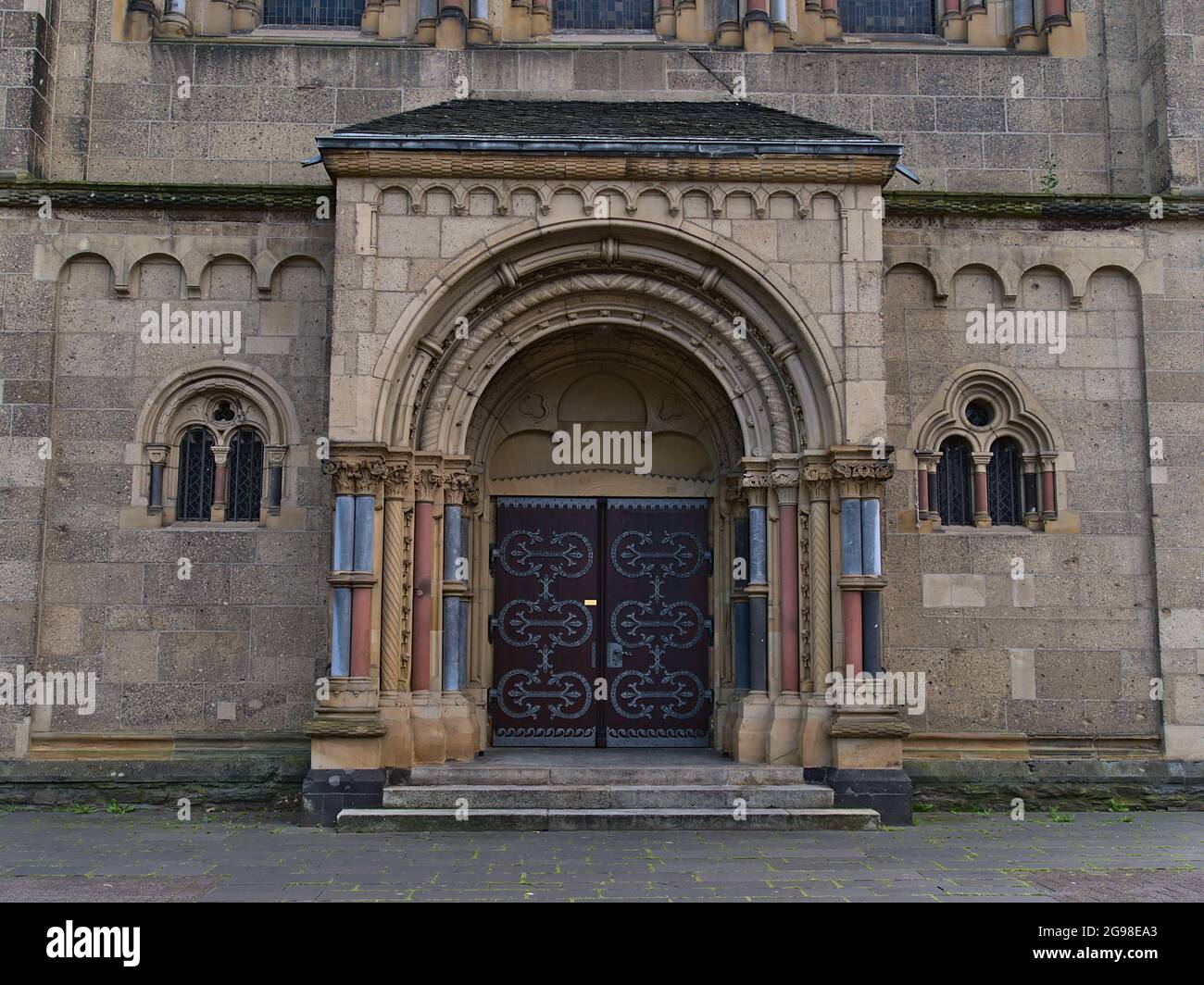 Symmetrical front view of decorated door of historic church Herz-Jesu ...