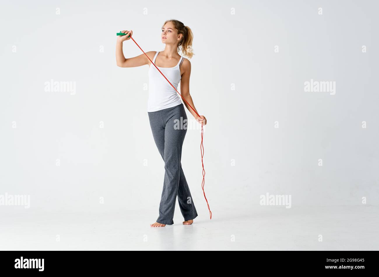 woman in sports uniform jumping rope in hands workout exercise light ...