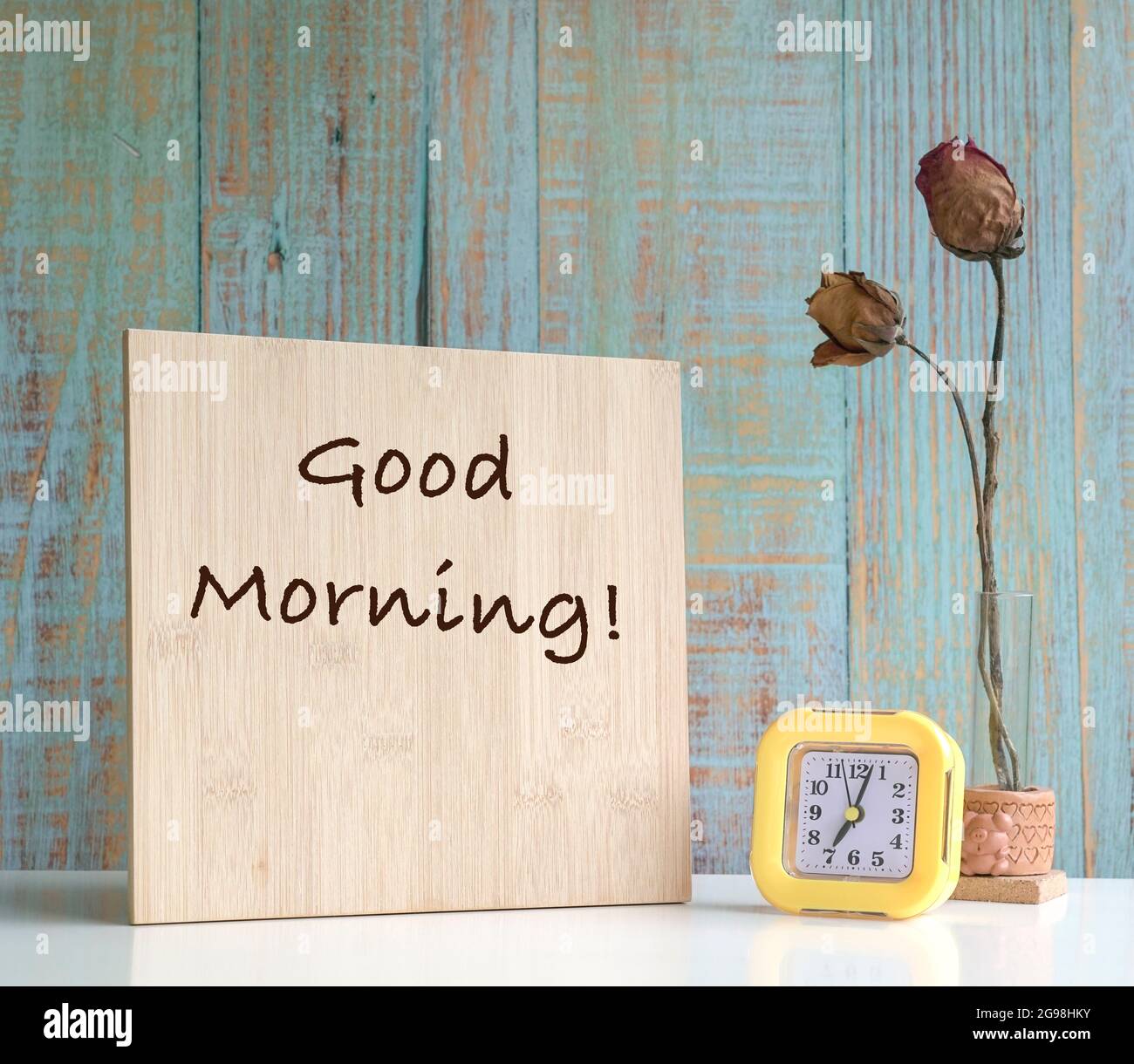 Wood board with the text good morning with clock and dried flowers in ...