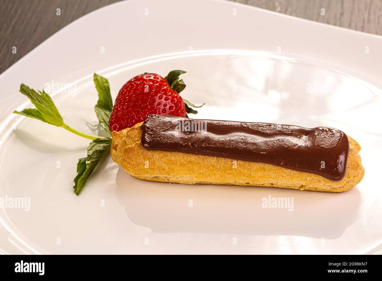 Sweet tasty eclair with chocolate icing Stock Photo - Alamy