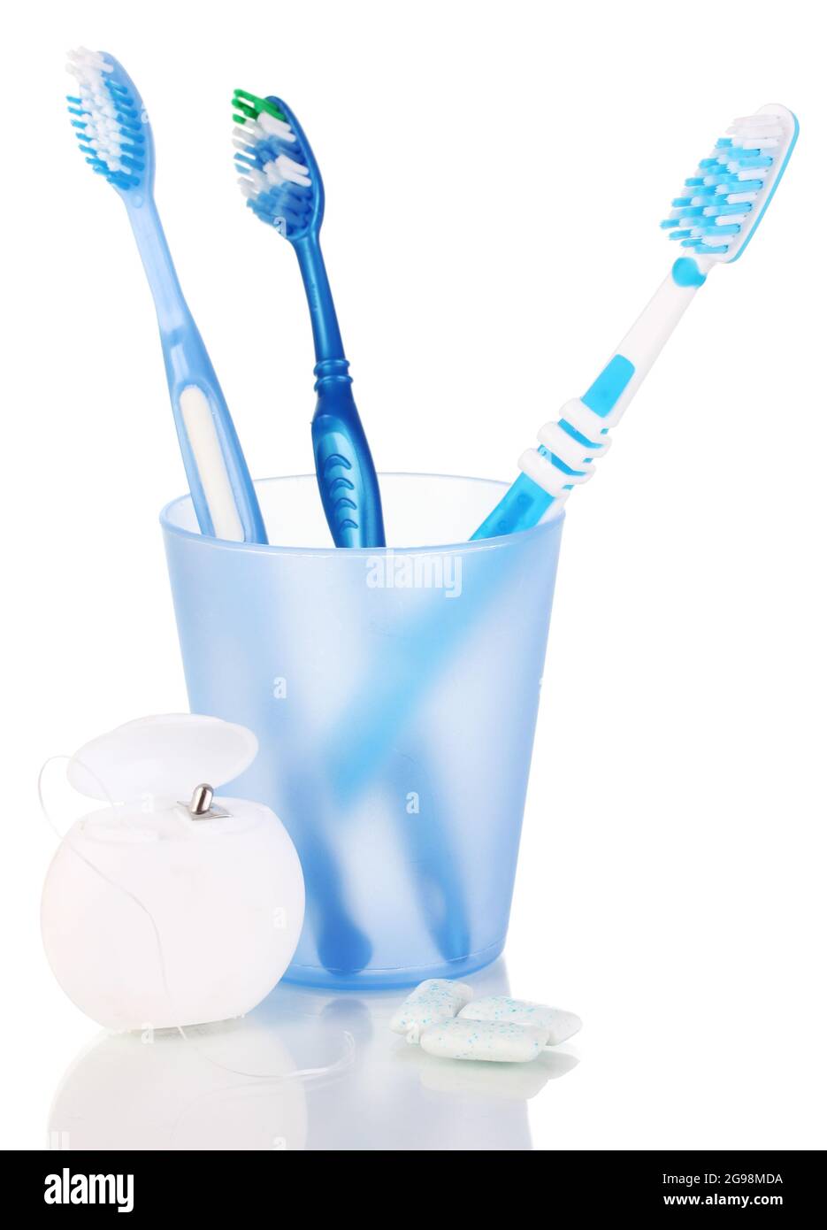 Toothbrushes, chewing gum and dental floss isolated on white Stock ...