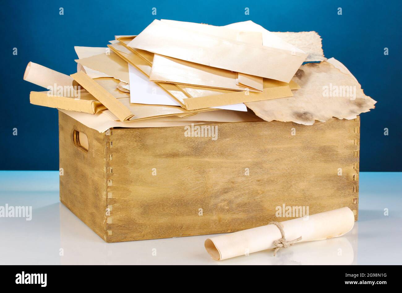 Wooden crate with papers and letters on blue background Stock Photo - Alamy