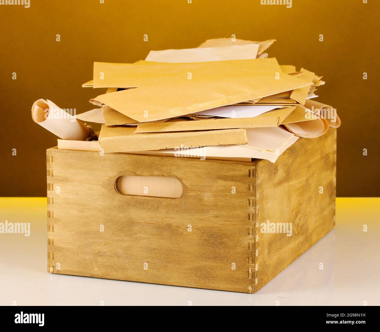Wooden crate with papers and letters on orange background Stock Photo ...