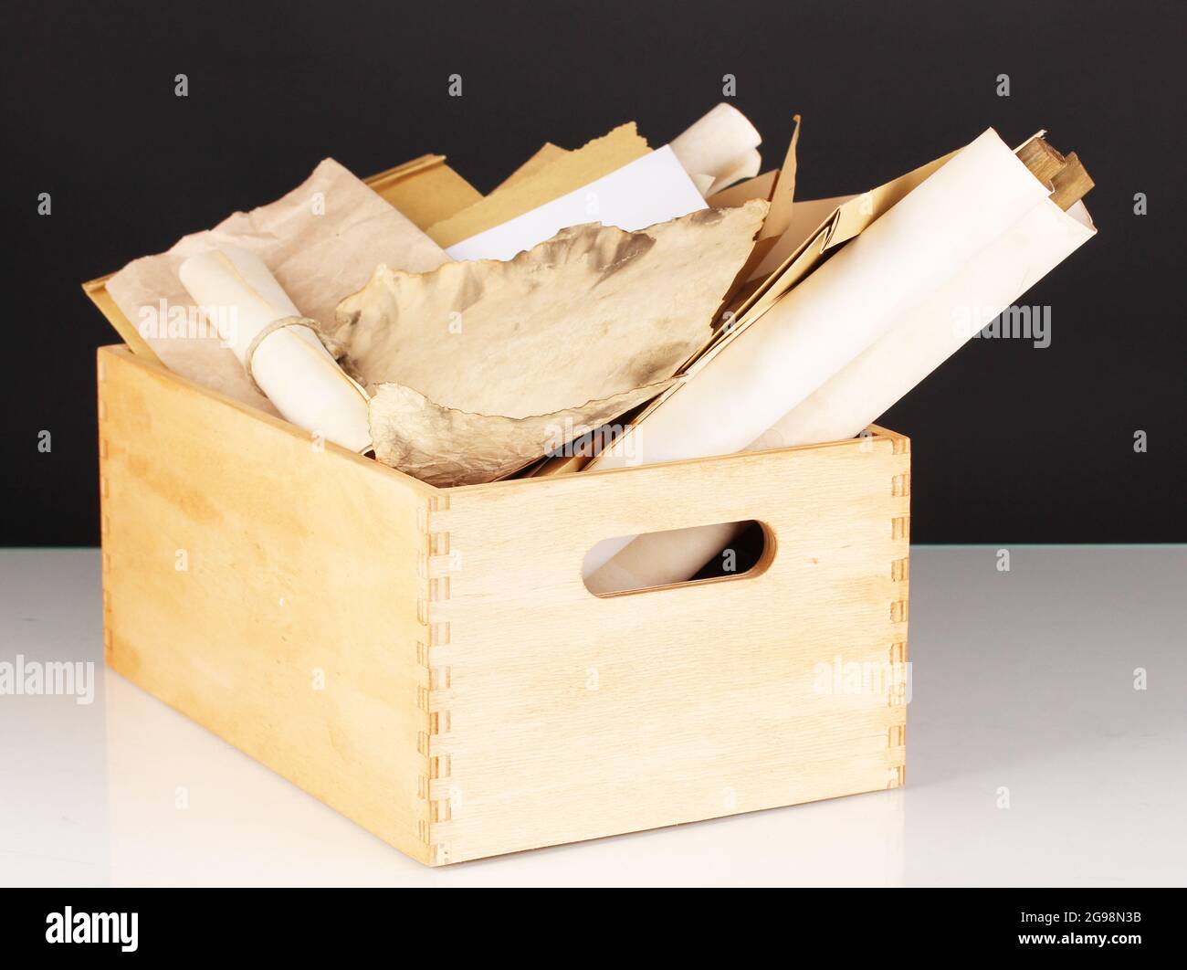 Wooden crate with papers and letters on black background Stock Photo ...