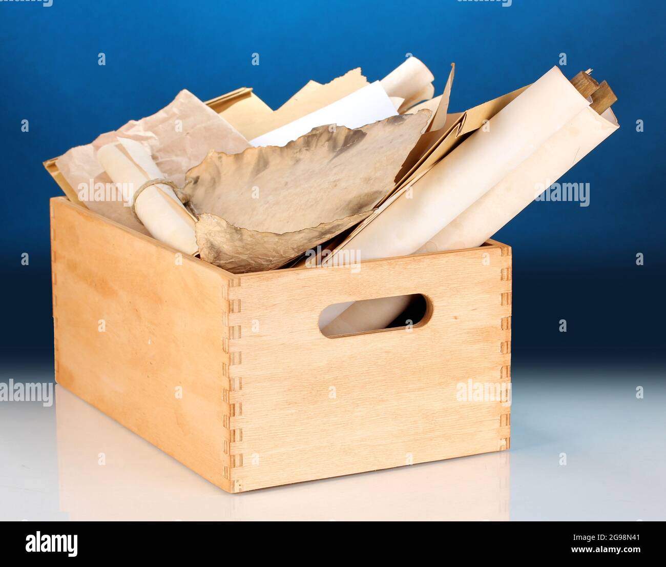 Wooden crate with papers and letters on blue background Stock Photo - Alamy