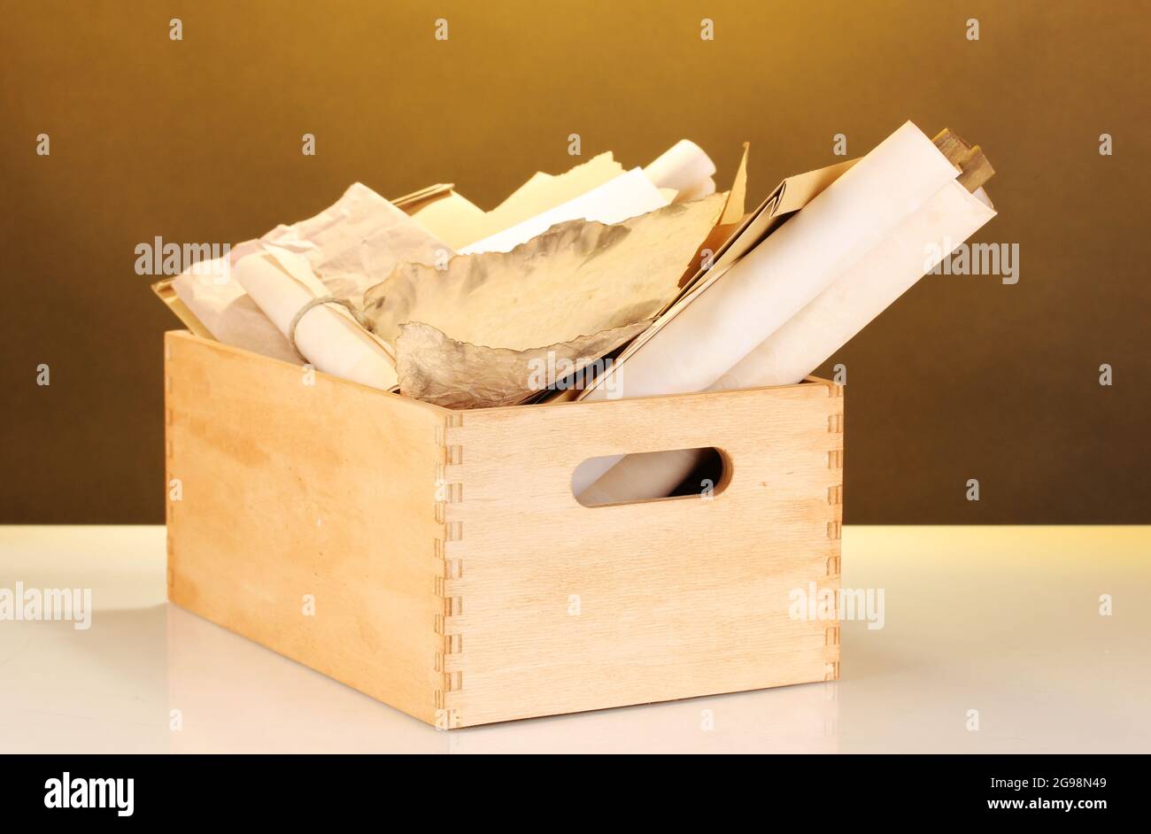 Wooden crate with papers and letters on orange background Stock Photo ...