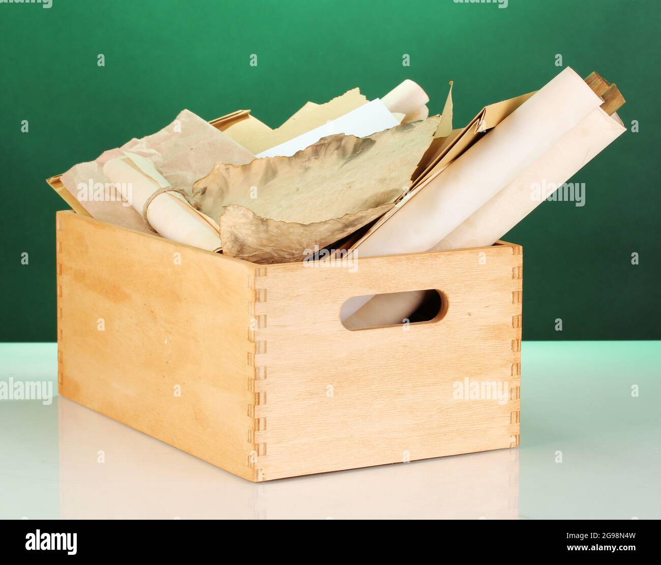 Wooden crate with papers and letters on green background Stock Photo ...