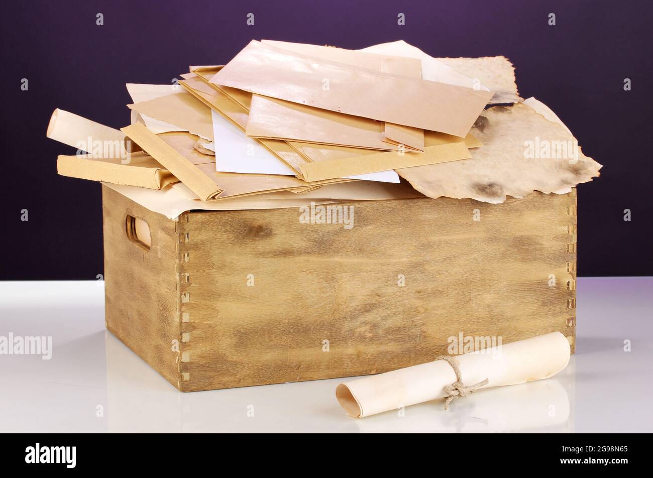 Wooden crate with papers and letters on purple background Stock Photo ...