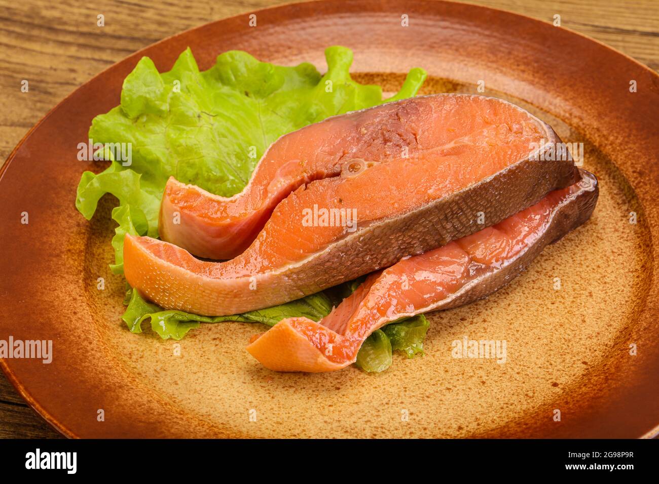 Two pink salmon fish steak served salad leaves Stock Photo - Alamy