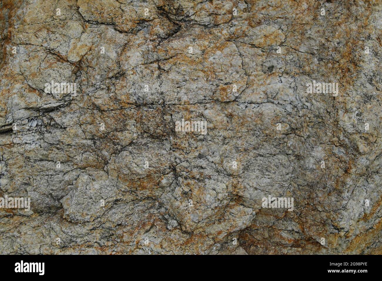 The texture of yellow-gray rock is rich in iron, giving a hint of rust ...