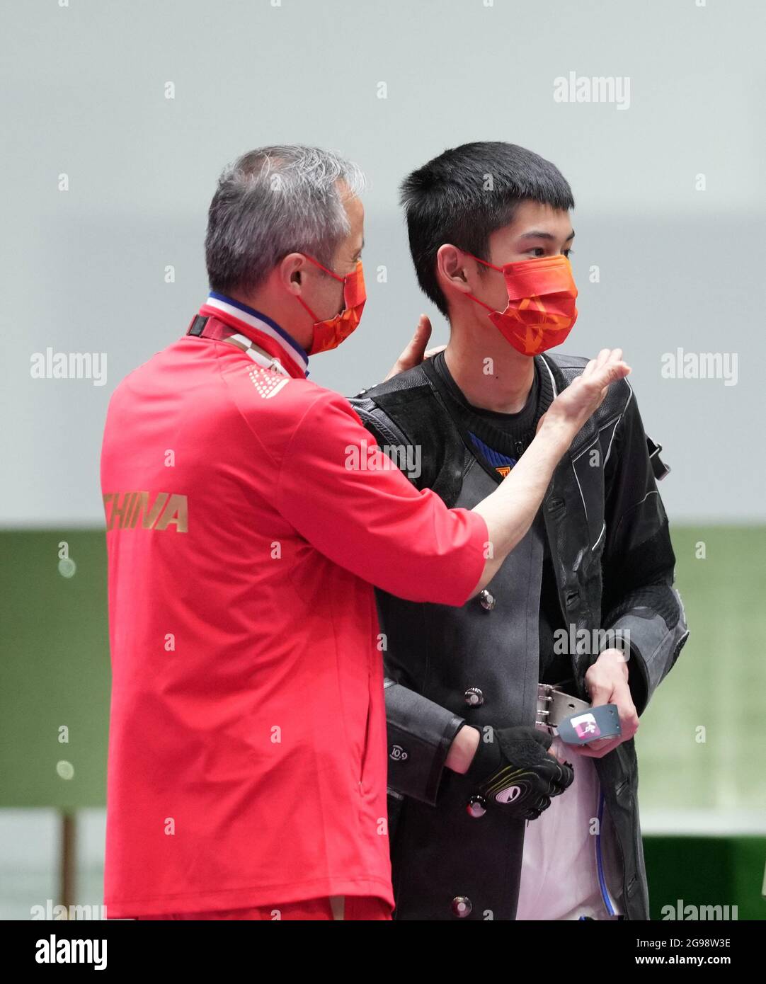 Tokyo, Japan. 25th July, 2021. Sheng Lihao (R) of China and his coach ...