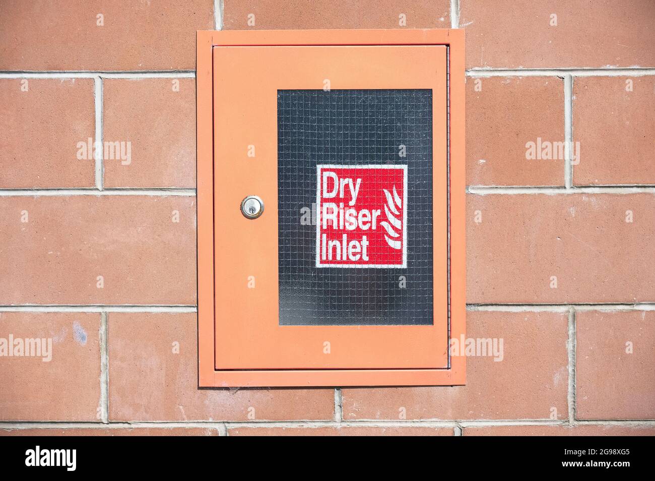 Dry riser red inlet box and sign at wall Stock Photo - Alamy