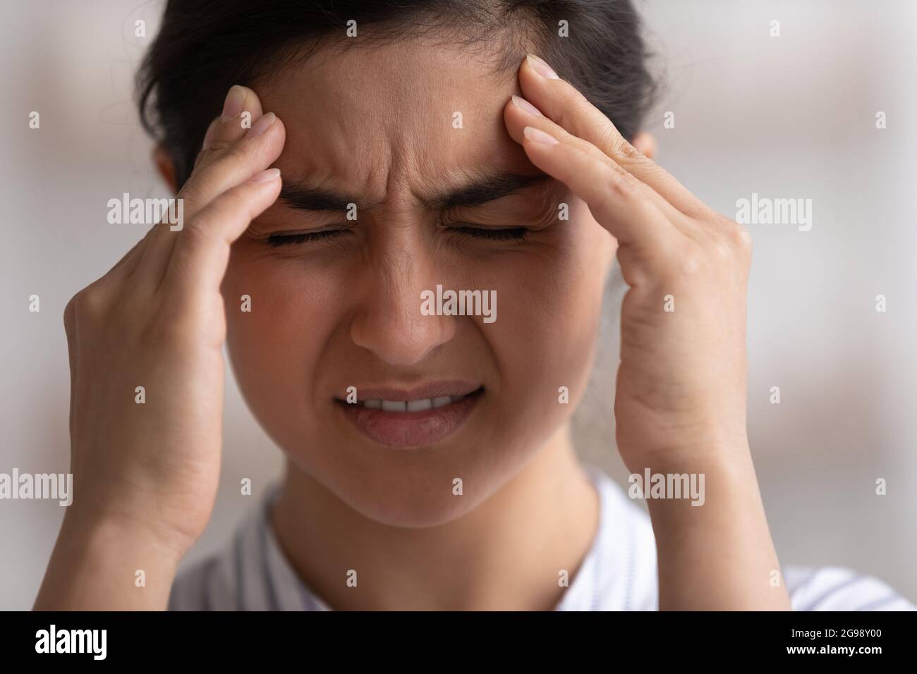 Head shot close up unhappy Indian woman feeling strong headache Stock ...