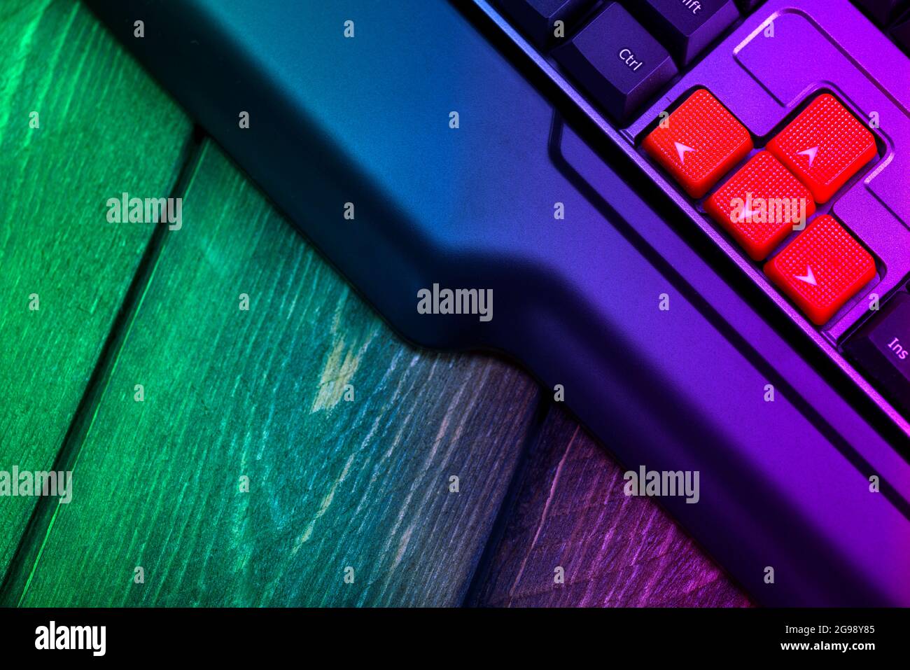 Close-up of orange arrow keys on a black keyboard, up, down, left ...